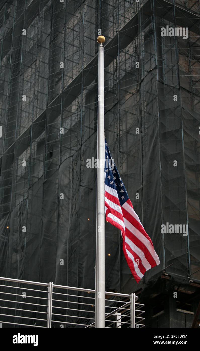 A flag flies at half staff in the shadow of the draped Deutsche Bank ...
