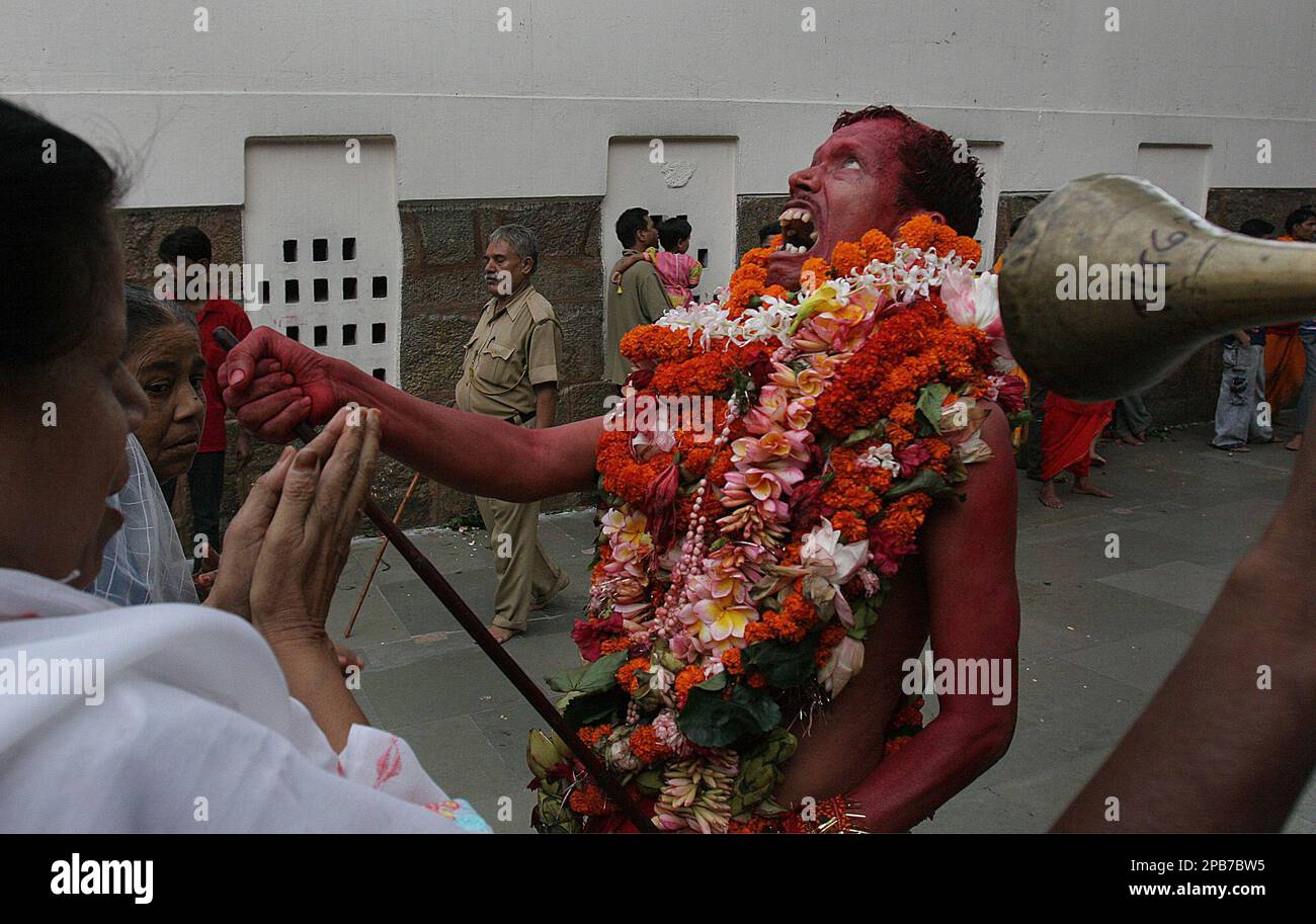 A priest with colors and blood of sacrificial goats and pigeons smeared ...
