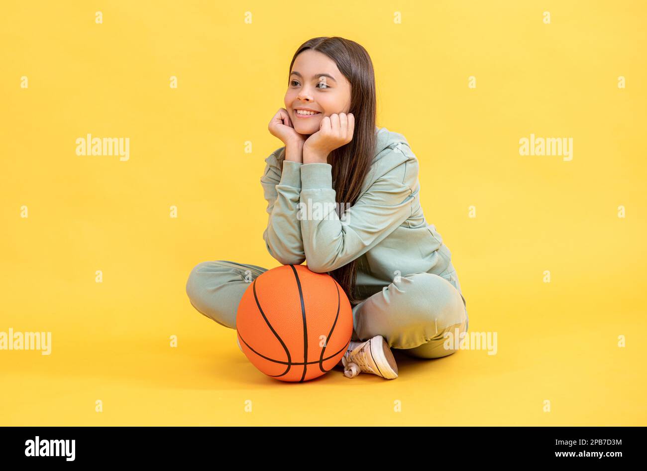 Girl sitting on basketball hi-res stock photography and images - Alamy