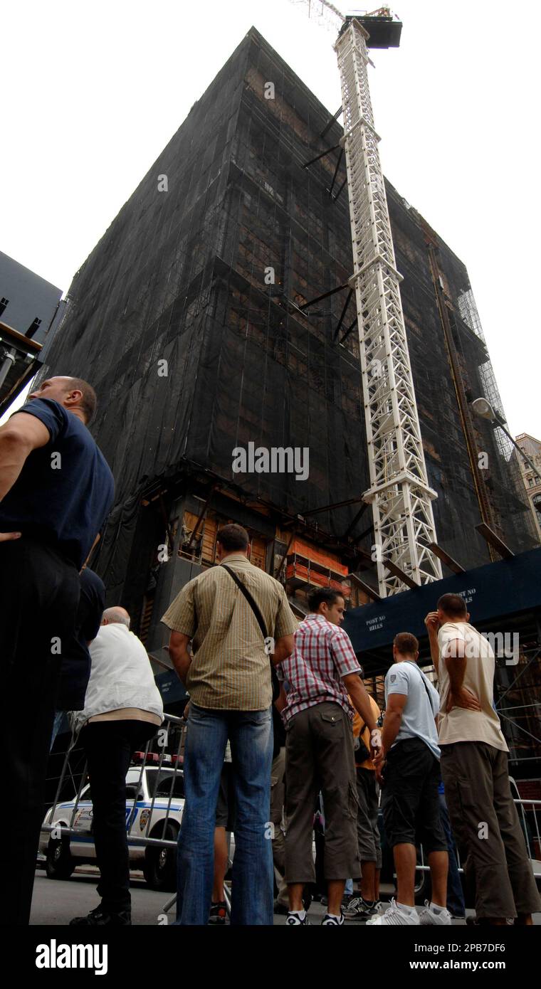 Onlookers gather in front of the former Deutsche Bank, Sunday, Aug. 19 ...