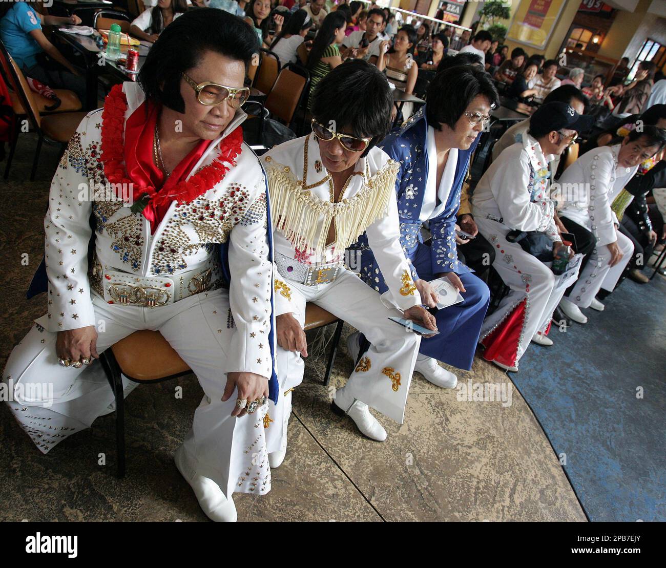 Filipino Elvis Presley impersonators wait for their turn during a ...