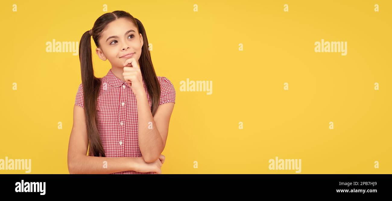 Start thinking big. Thoughtful girl yellow background. School age child ...