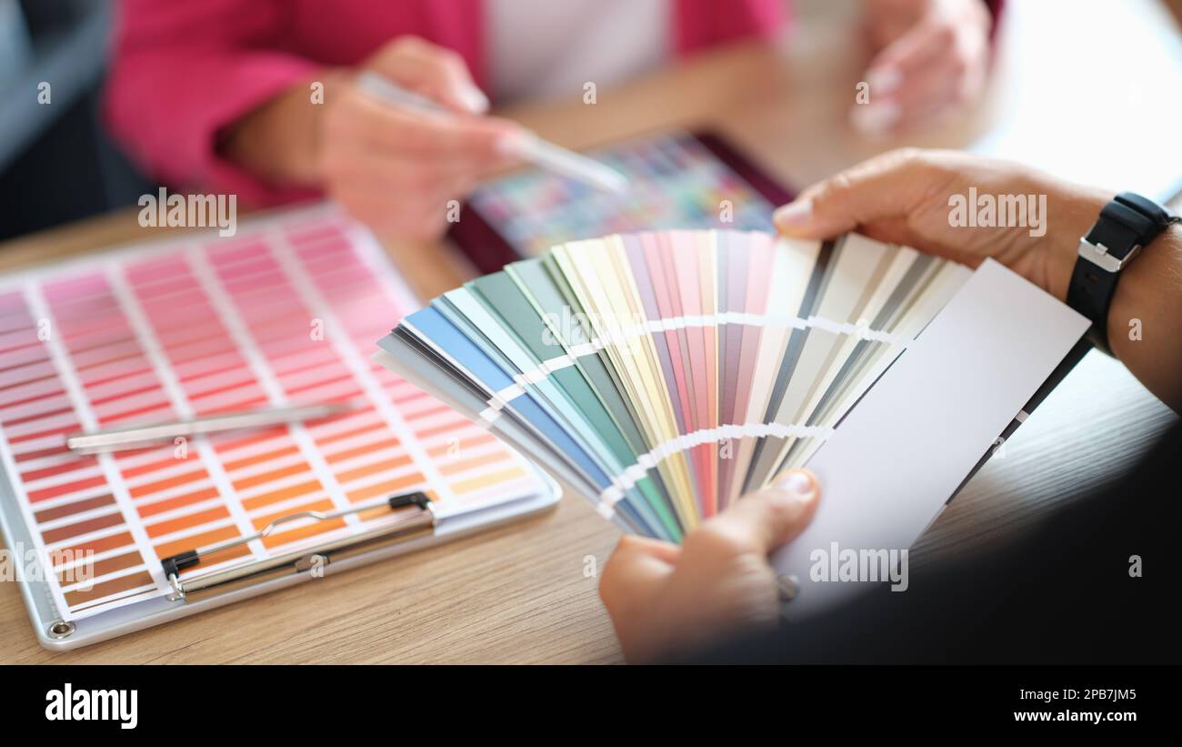 Designer and her client choosing colors for home renovation Stock Photo ...