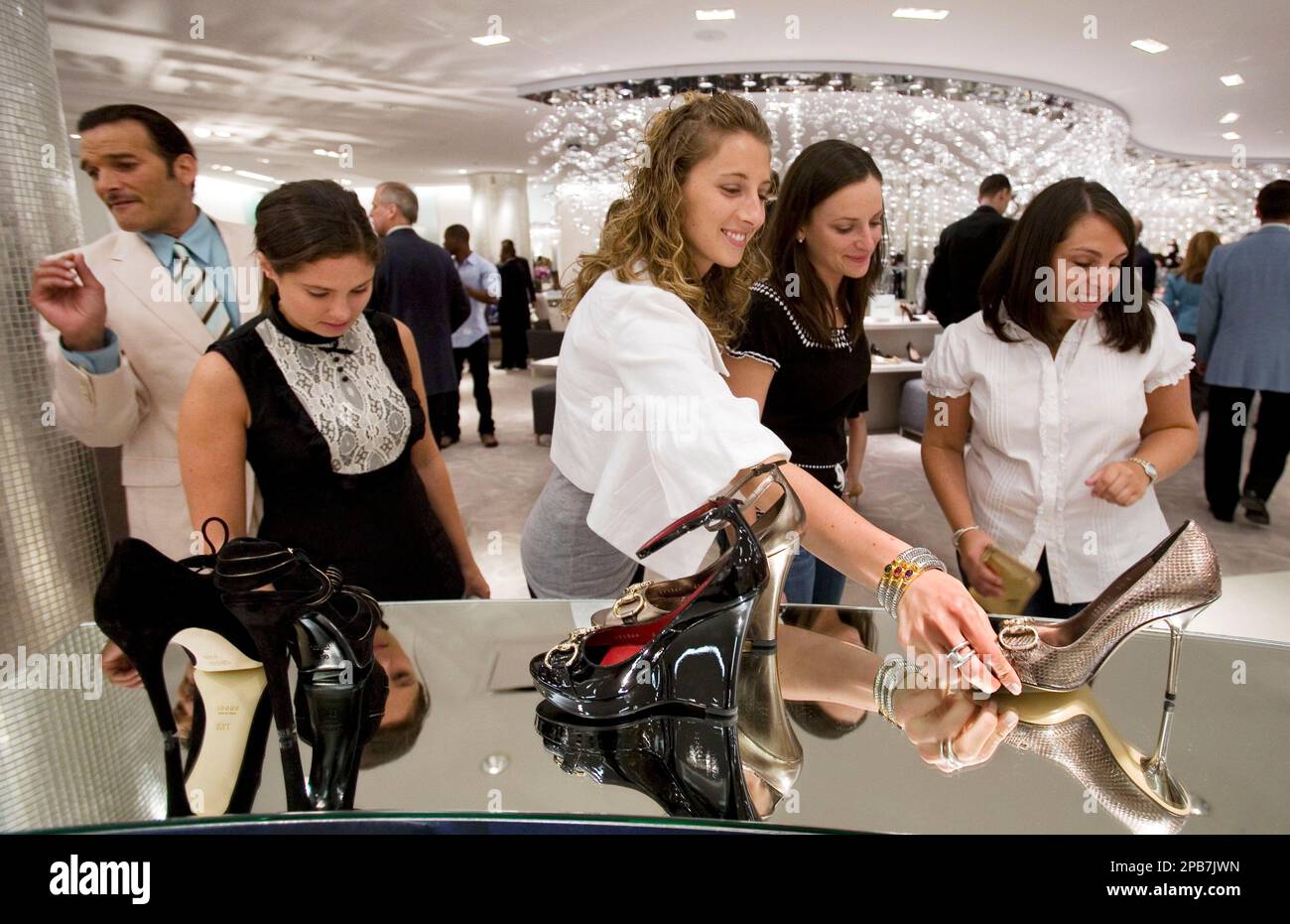 Heather Babby reaches for a shoe at Saks Fifth Avenue's newly opened ...