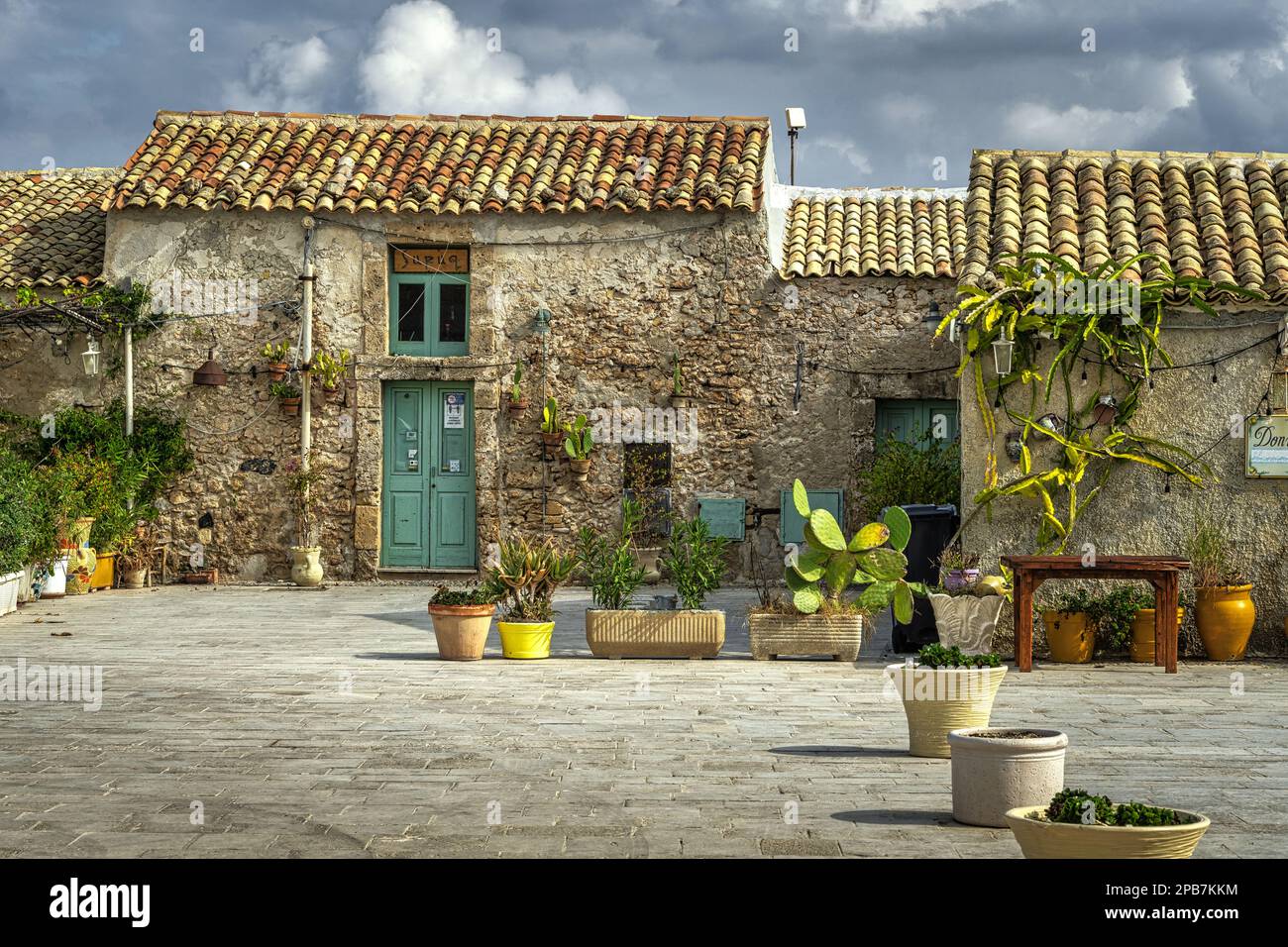 Glimpses of the Sicilian seaside village of Marzamemi with the houses ...