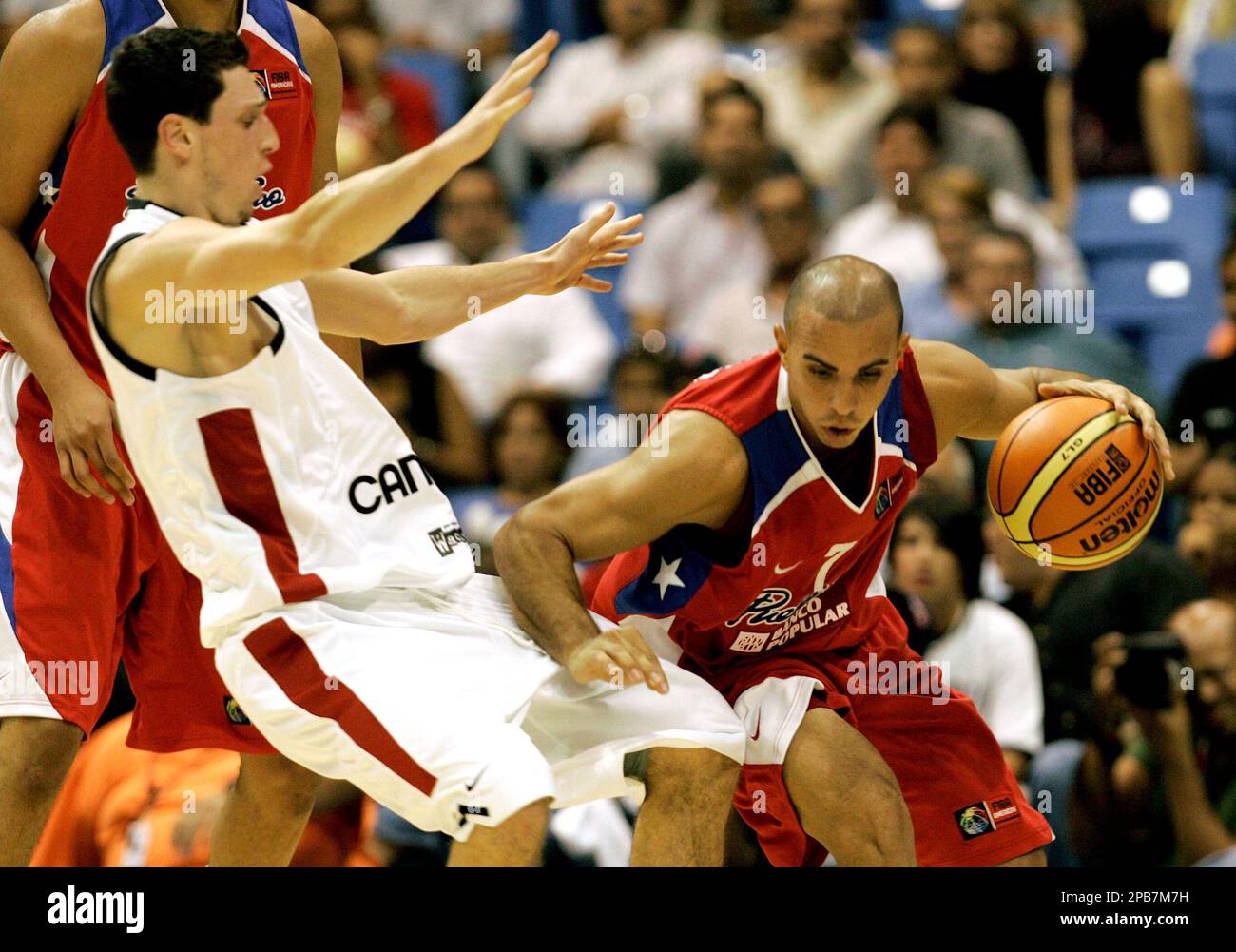 Puerto Rico's Carlos Arroyo, right, drives with the ball as he is ...