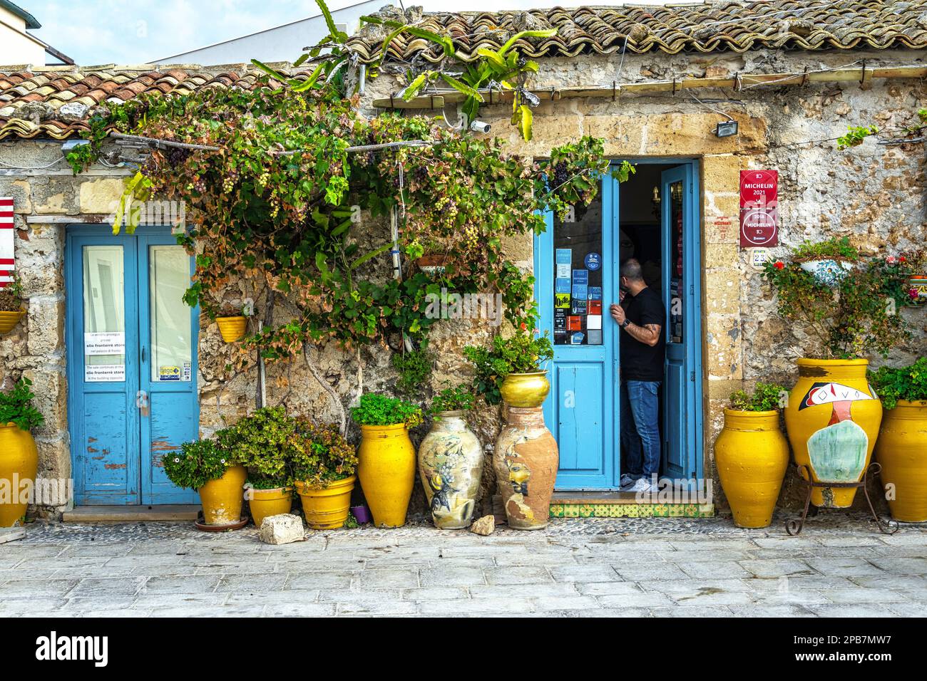 Glimpses of the Sicilian seaside village of Marzamemi with the houses ...
