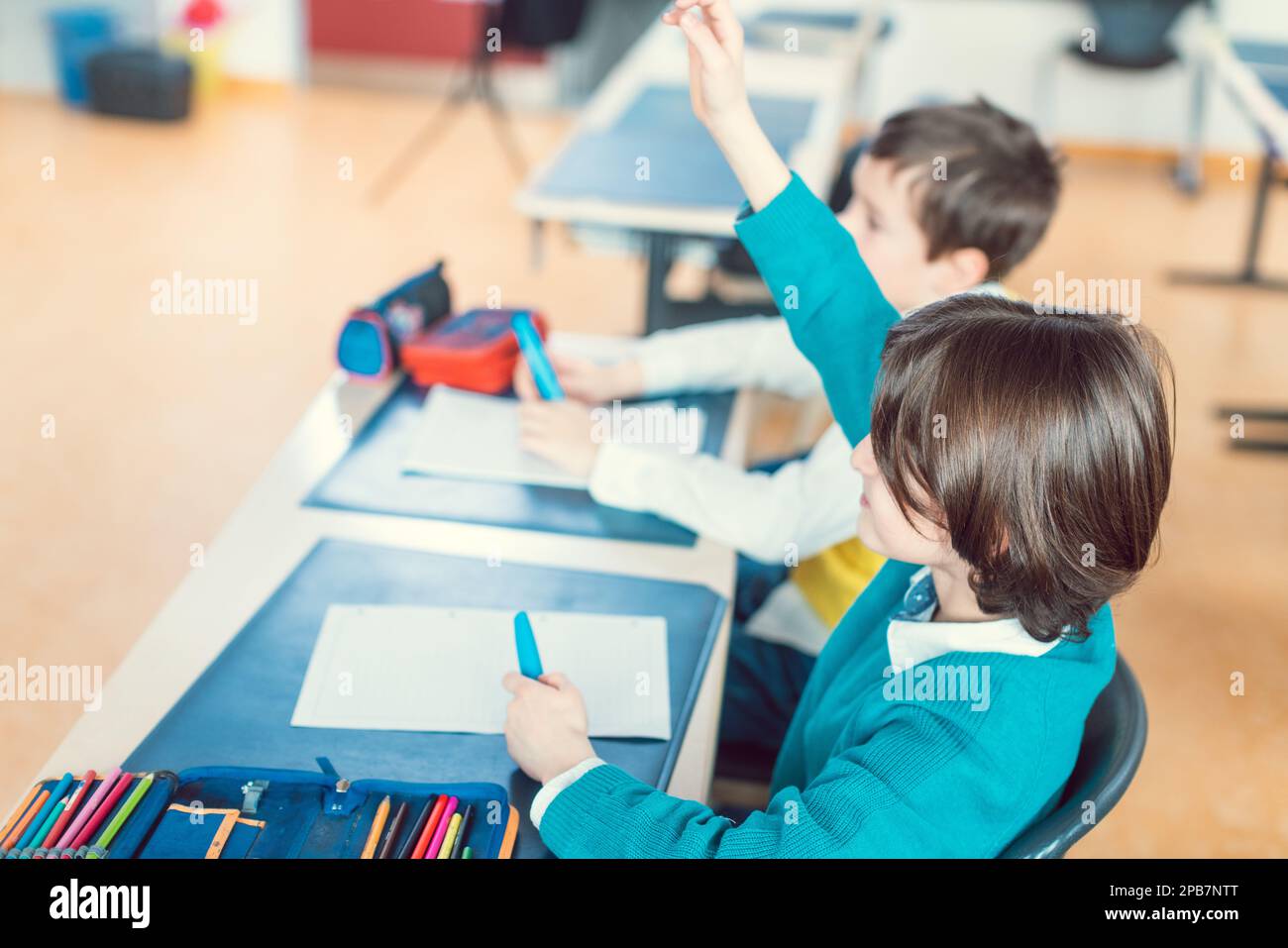 Schoolboy raising hand answer hi-res stock photography and images - Alamy