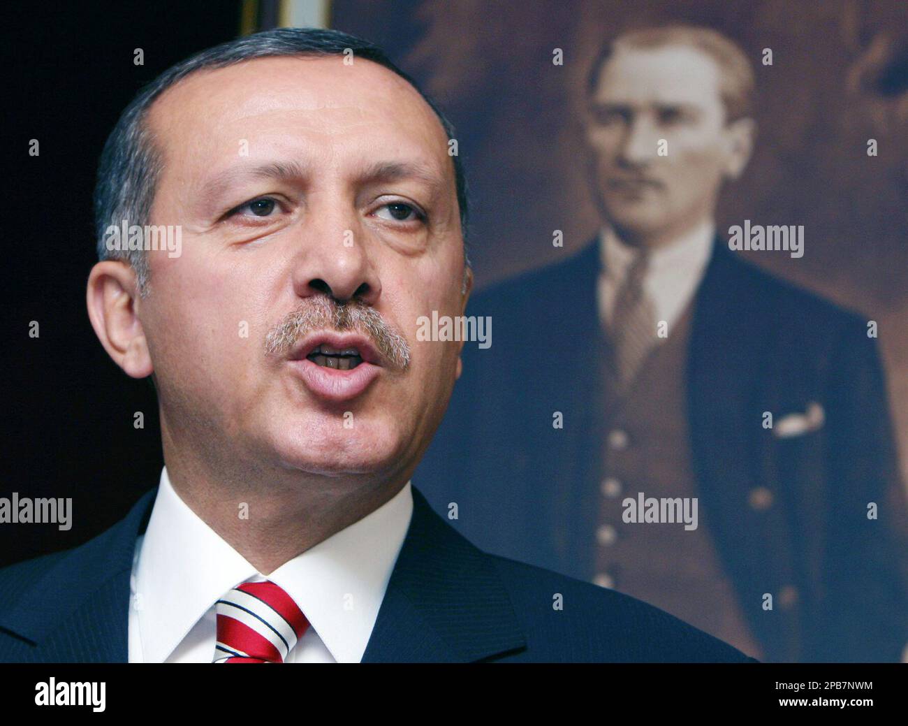 Turkish Prime Minister Recep Tayyip Erdogan speaks to the media, with a ...