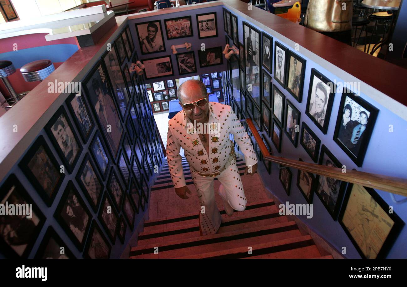 An Israeli fan of Elvis Presley, dressed like the late singer, walks in ...