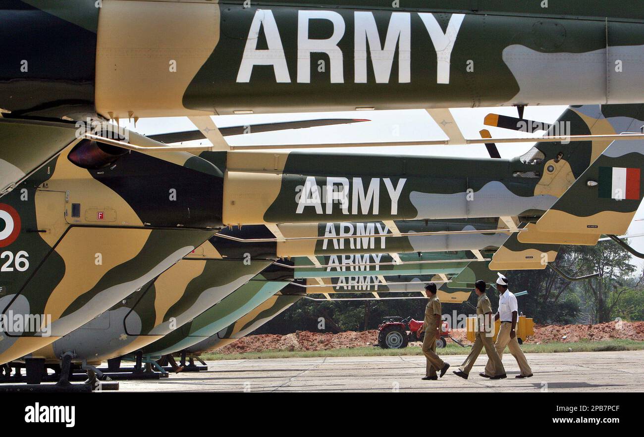 Hindustan Aeronautics Limited (HAL) officials walk past the new version ...