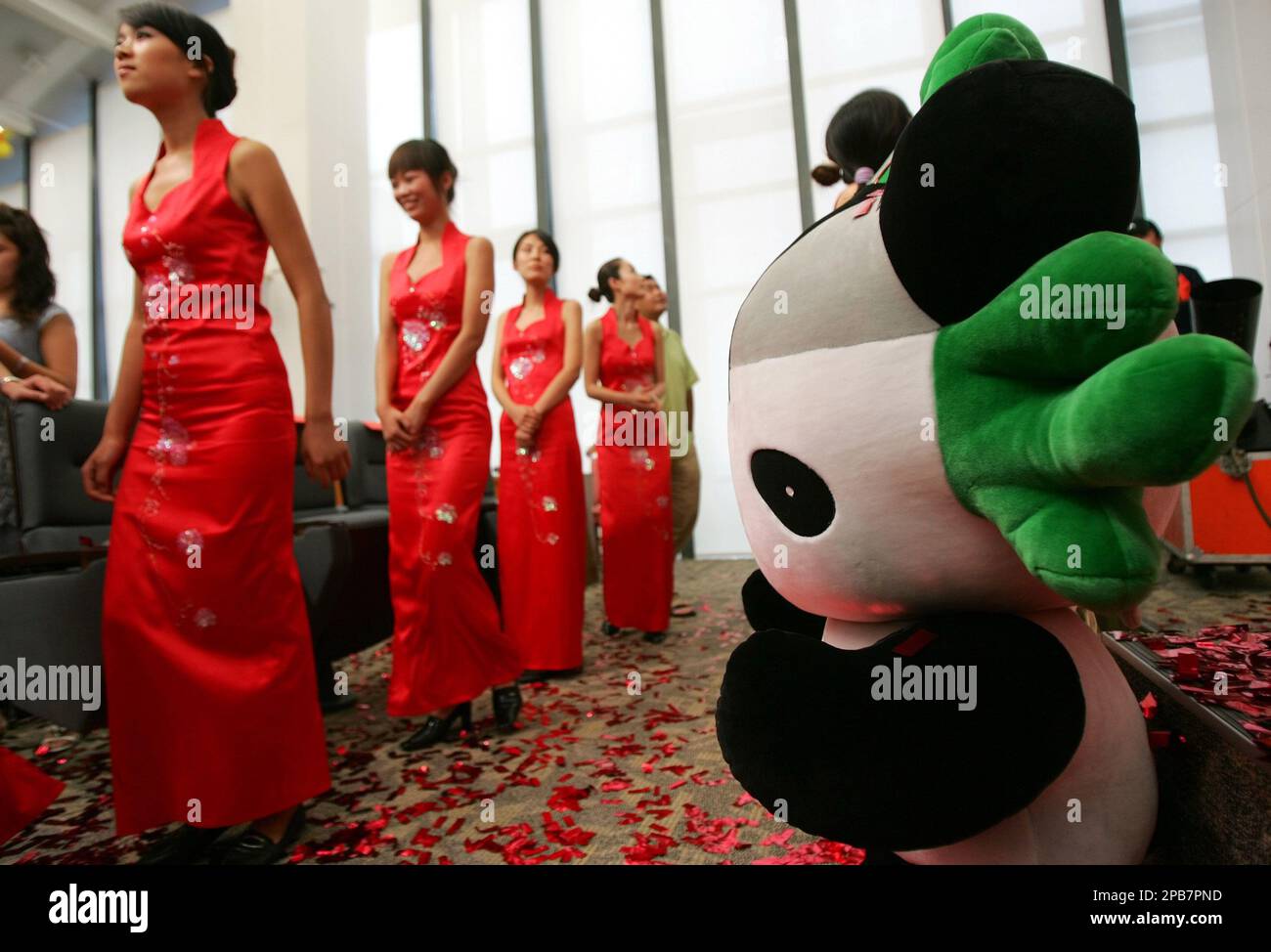 Ushers walk past an Olympic mascot, known collectively as Fuwa, at a ...