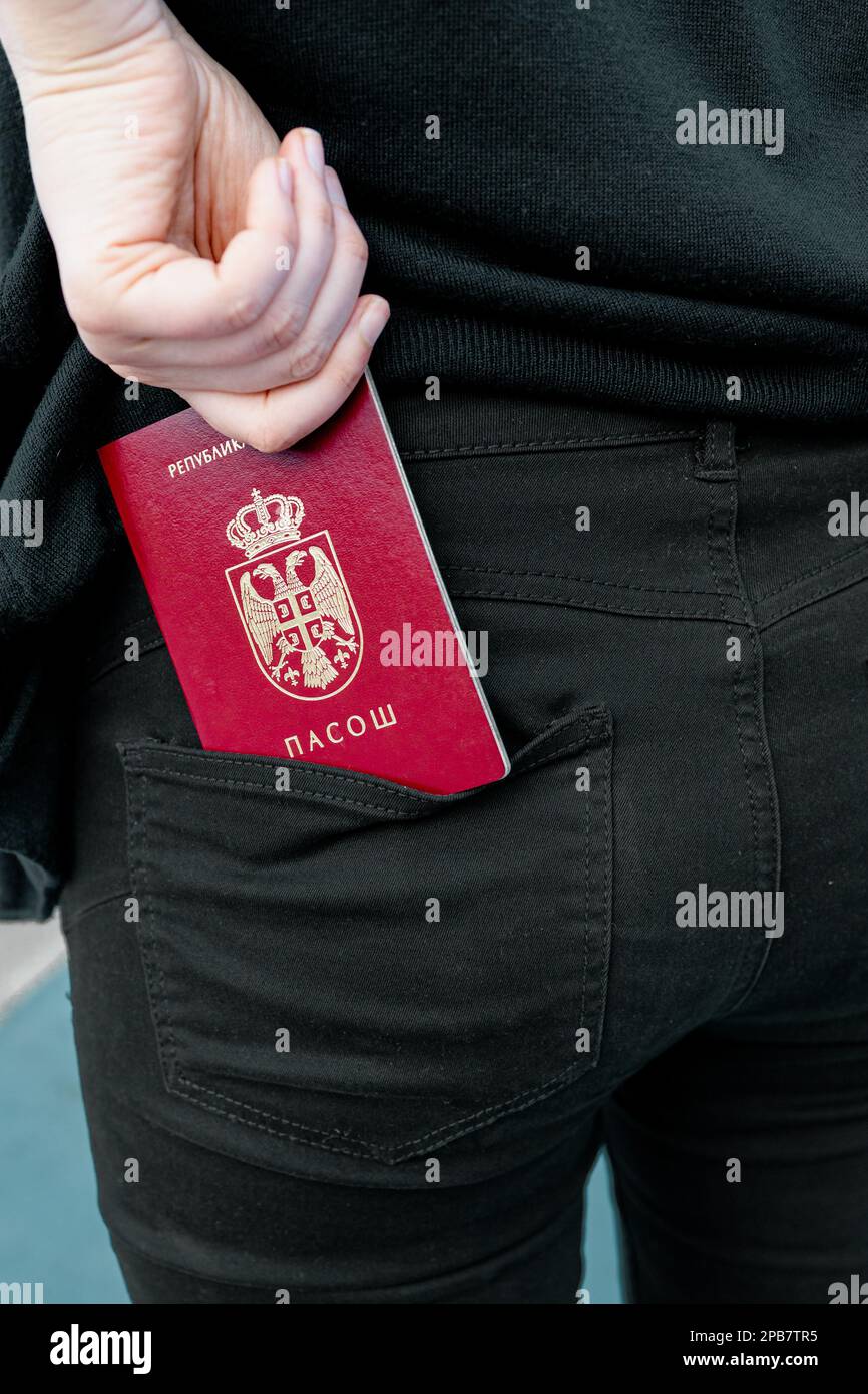 Woman taking out her Serbian passport from her back pocket Stock Photo ...