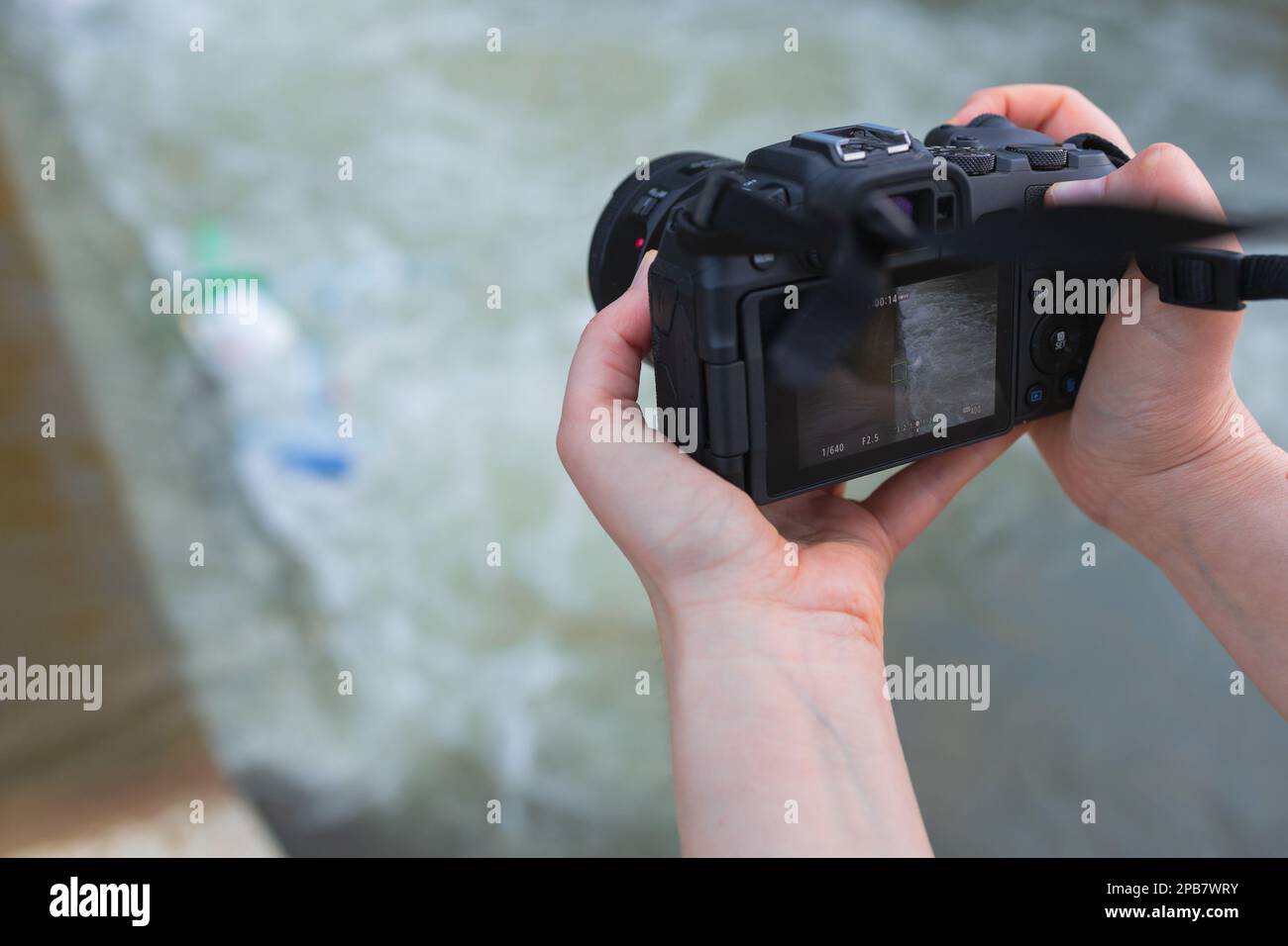 Female hands holding mirrorless camera making outdoors photos Stock ...