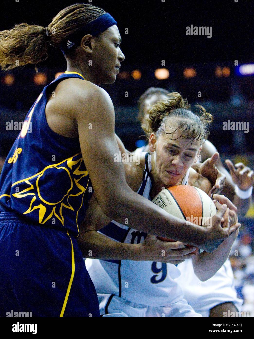 Washington Mystics' Coco Miller, right, pulls down a rebound against ...