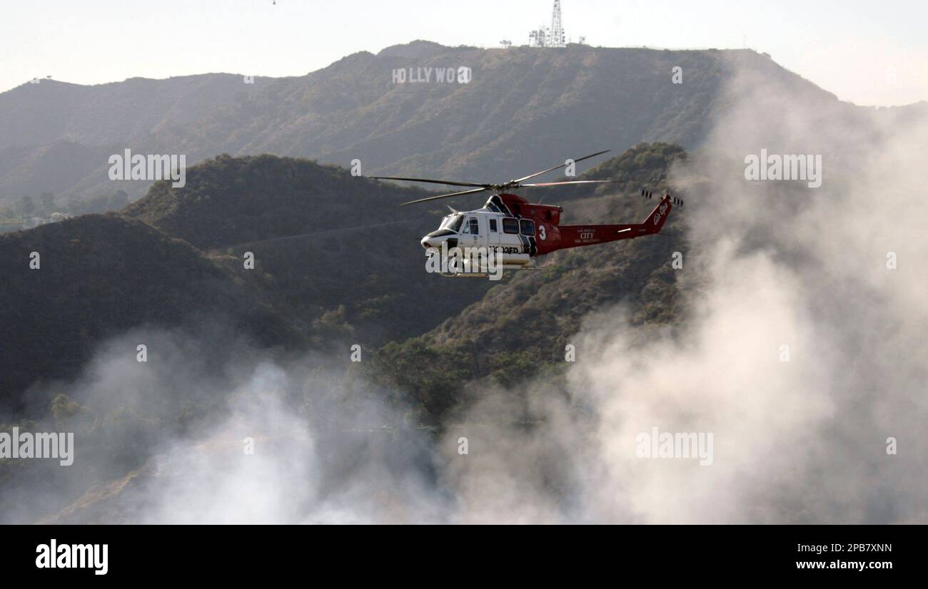 A Los Angeles Fire Department helicopter flys over a small brush fire ...