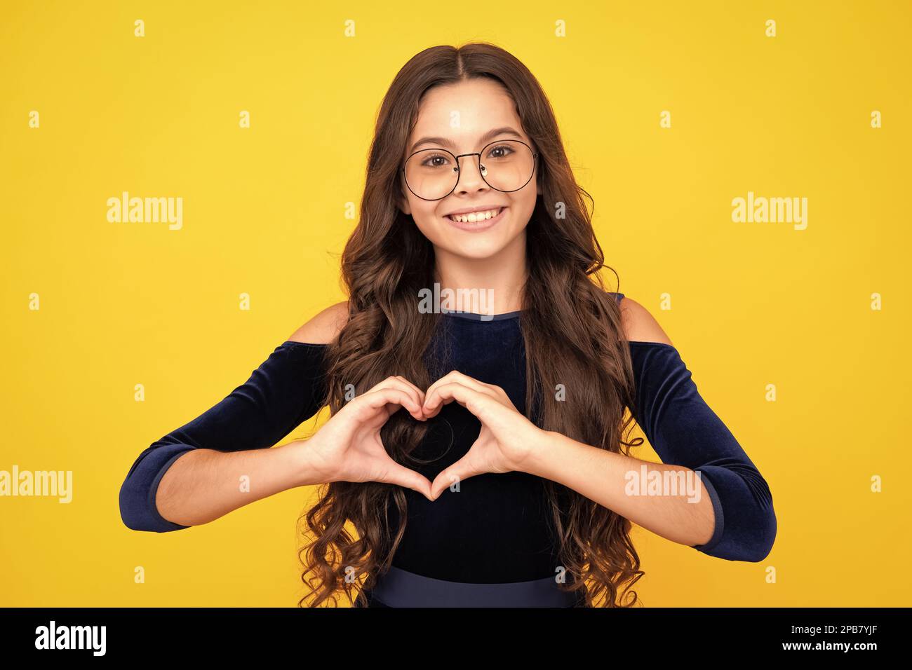 Child hands making sign heart by fingers. Valentines Day. Dreaming cute ...