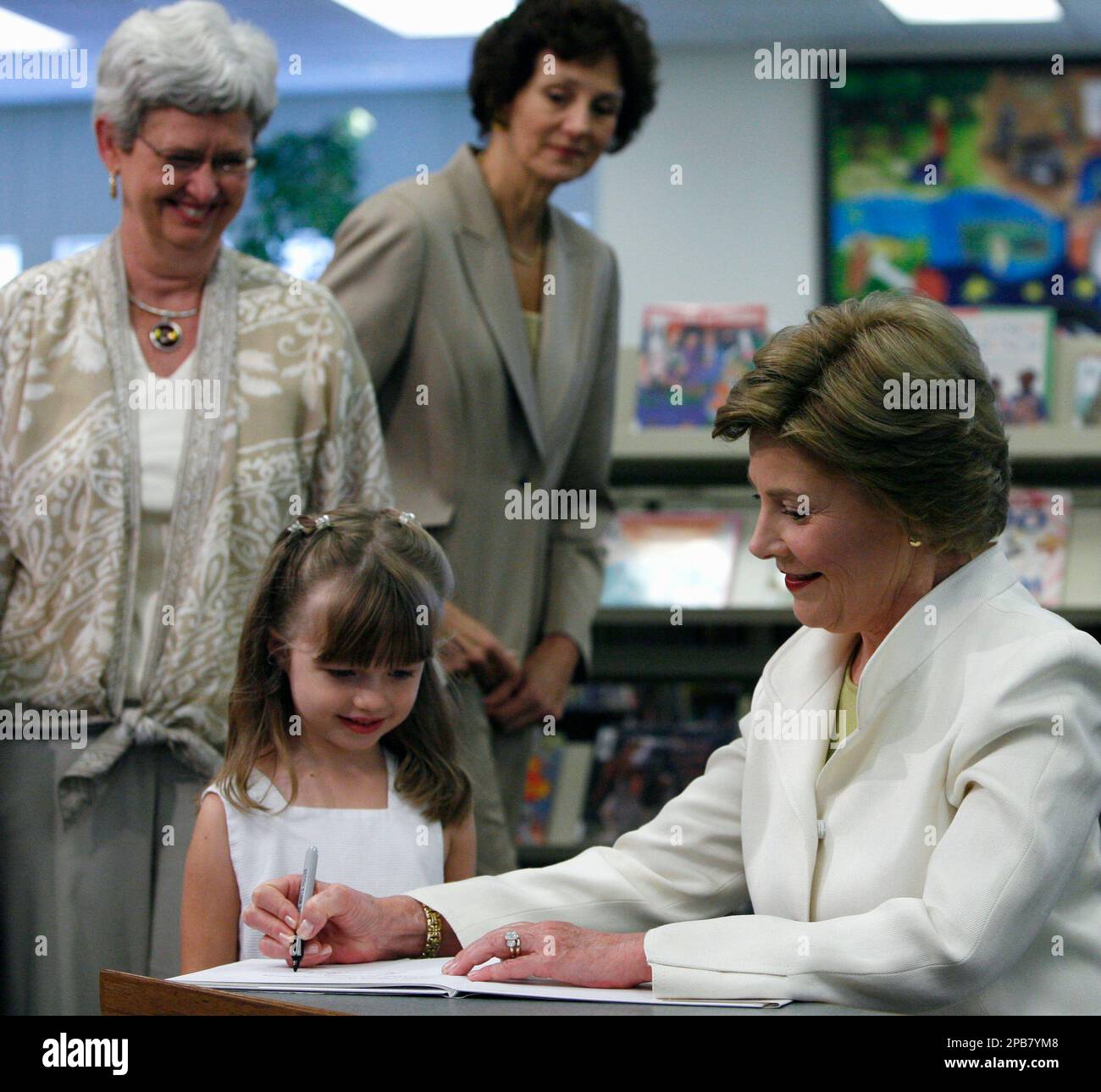 First lady Laura Bush, right, signs a book at the Westbank Community ...