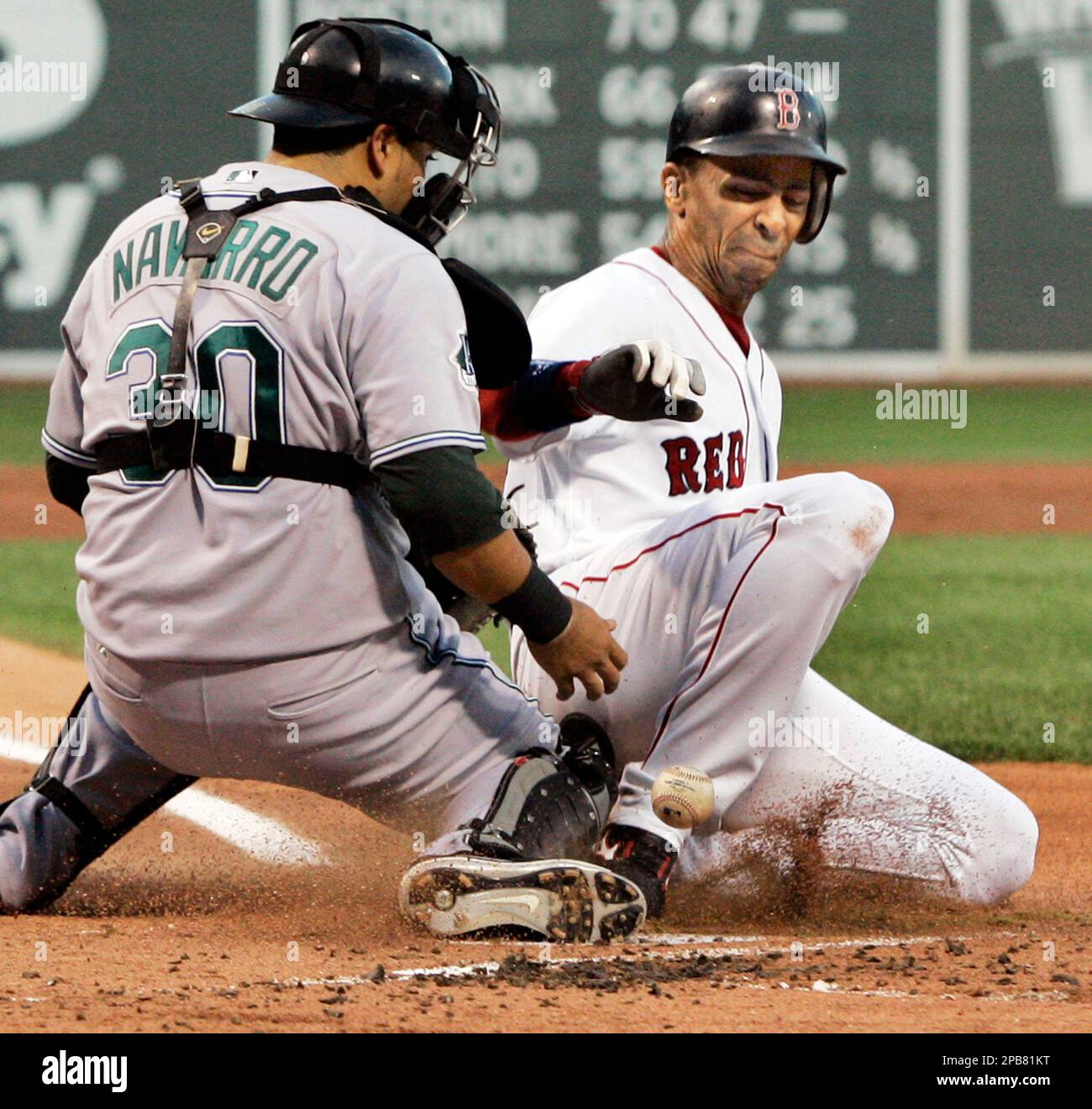 Boston Red Sox's Julio Lugo slides safely into home as Tampa Bay Devil ...