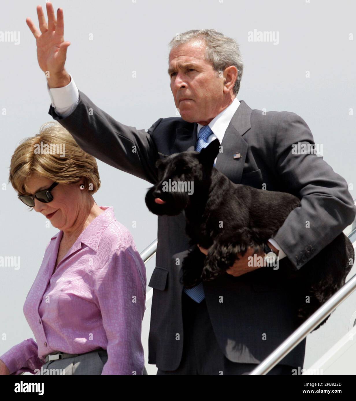 President Bush and first lady Laura Bush, left, walk down the stairs of ...