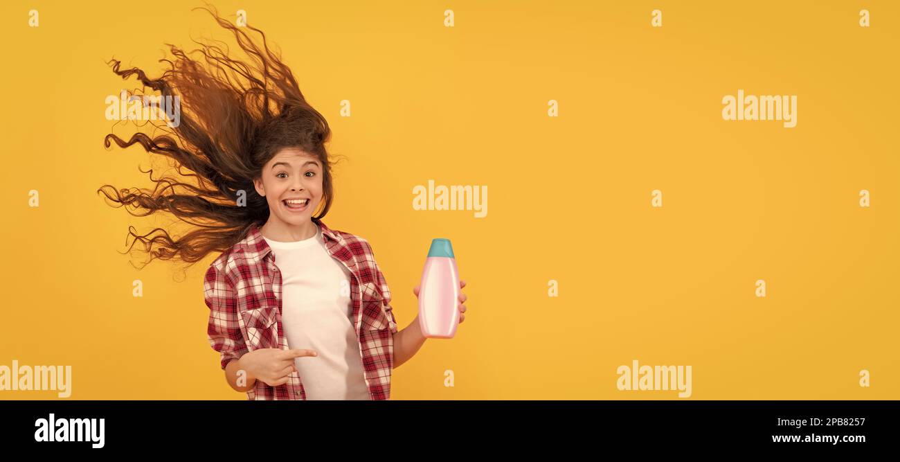 kid use shower gel. happy teen girl with shampoo bottle. shampooing ...