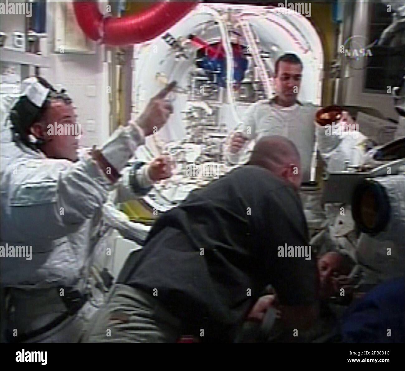 In this image from NASA TV Canadian astronaut Dave Williams, left ...