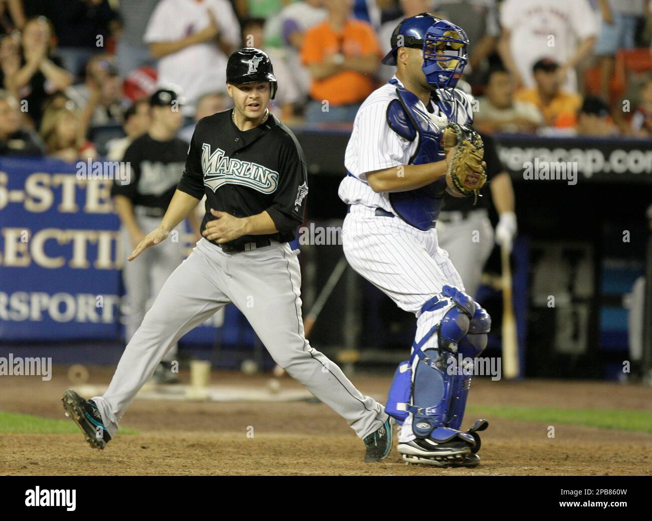 Florida Marlins' Cody Ross, left, crosses home plate, off a single by ...