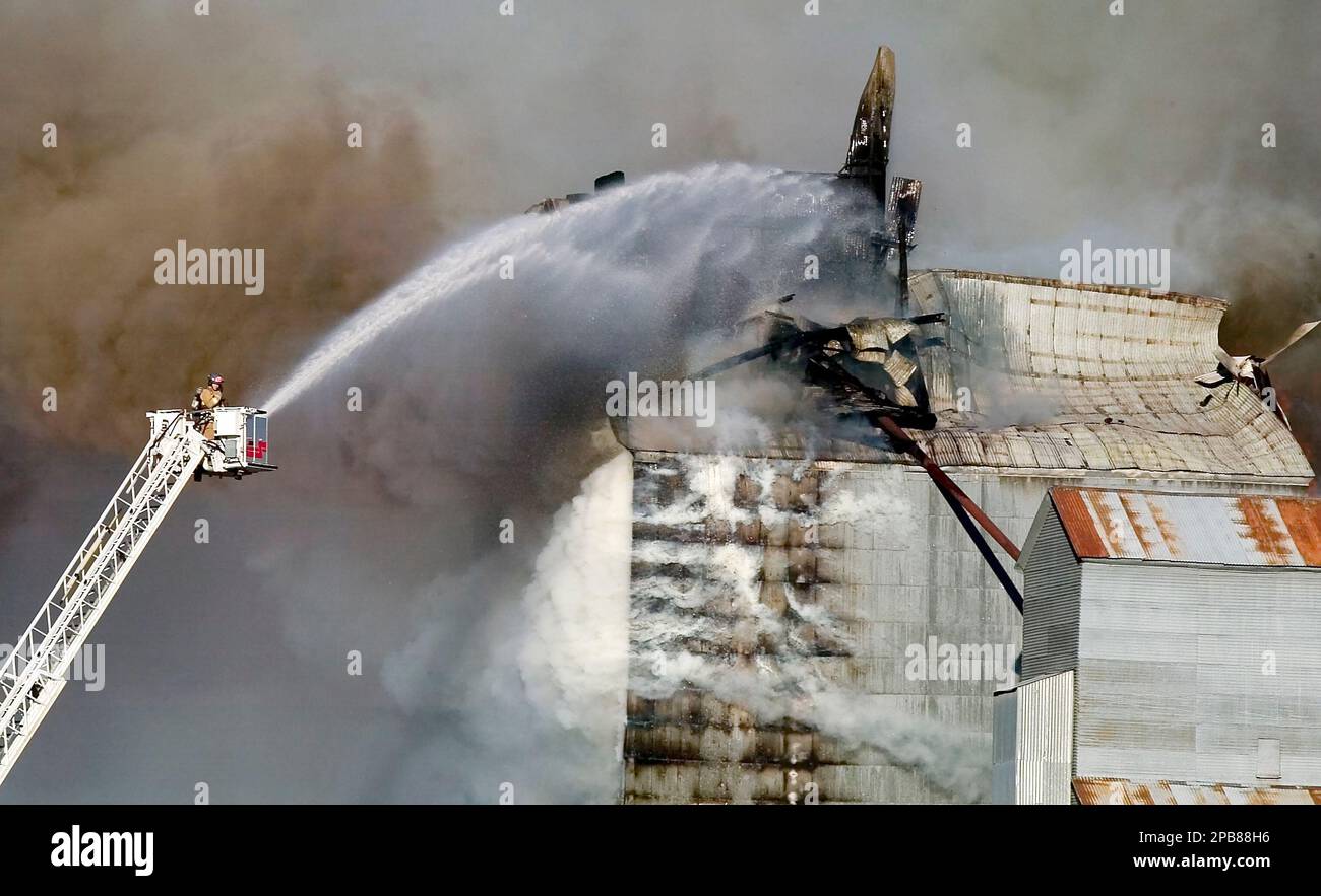 Pullman firefighter Jay Wilkins directs water onto the Carl Boyd grain ...