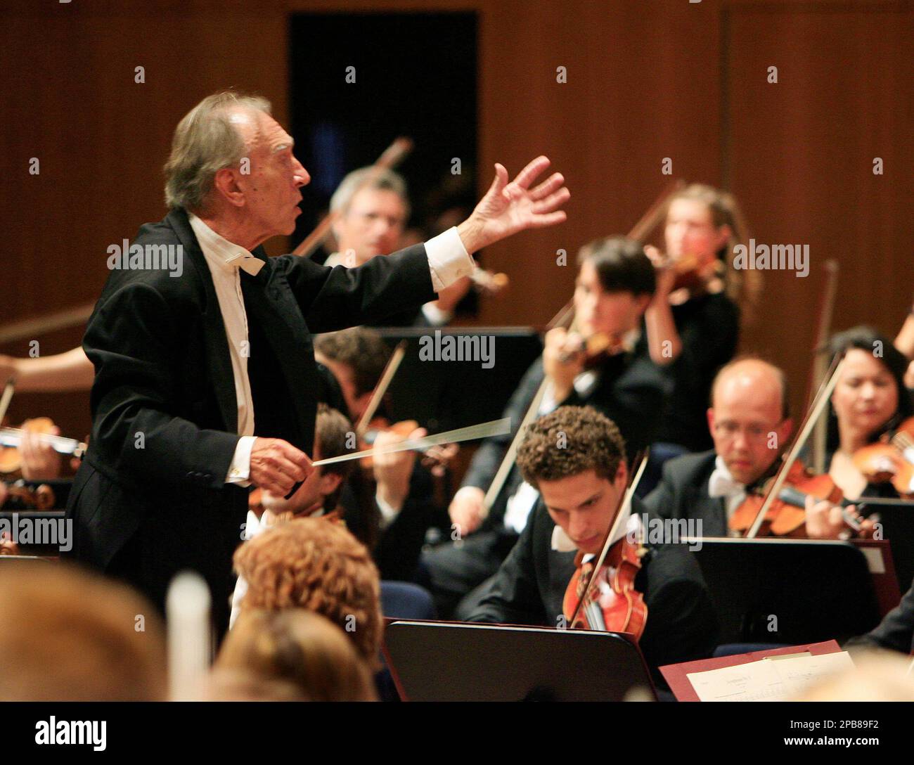 World famous Italian conductor Claudio Abbado, left, conducts his ...