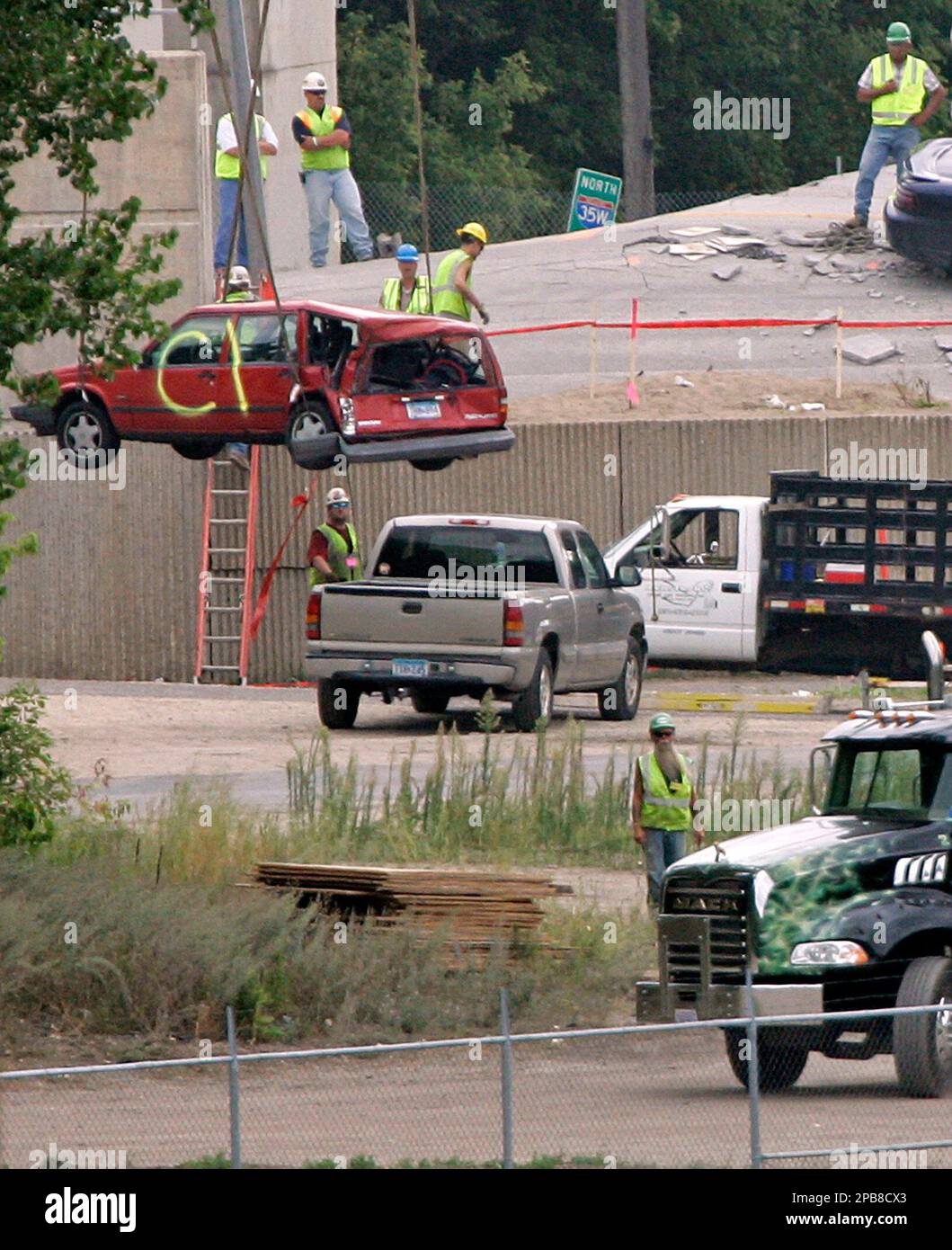 A vehicle is hoisted off the interstate 35W bridge collapse site in ...