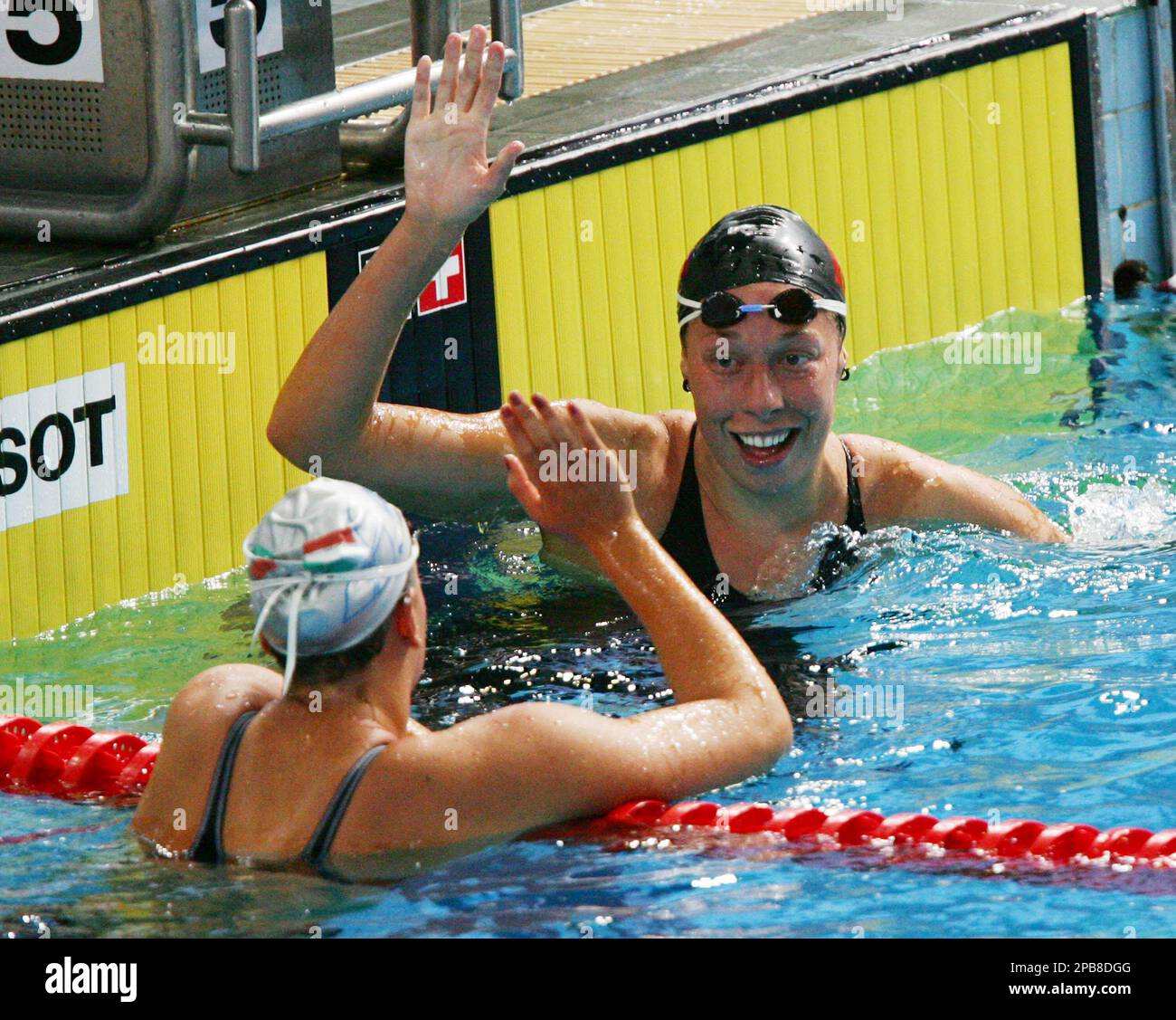 Swiss swimmer Flavia Rigamonti, top, smiles at Italy's Federica ...
