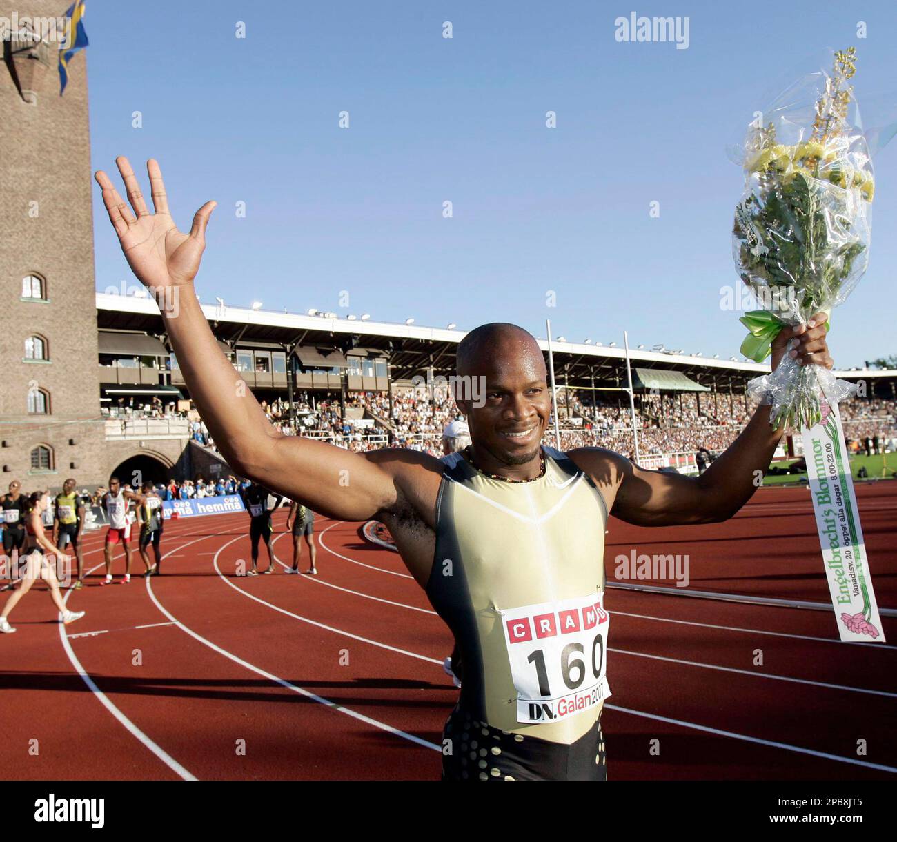 Asafa Powell of Jamaica celebrates after winning the men's 100m event ...