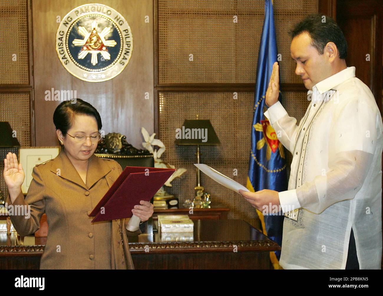 President Gloria Macapagal Arroyo, left, swears in into office Gilbert Teodoro as the new ...