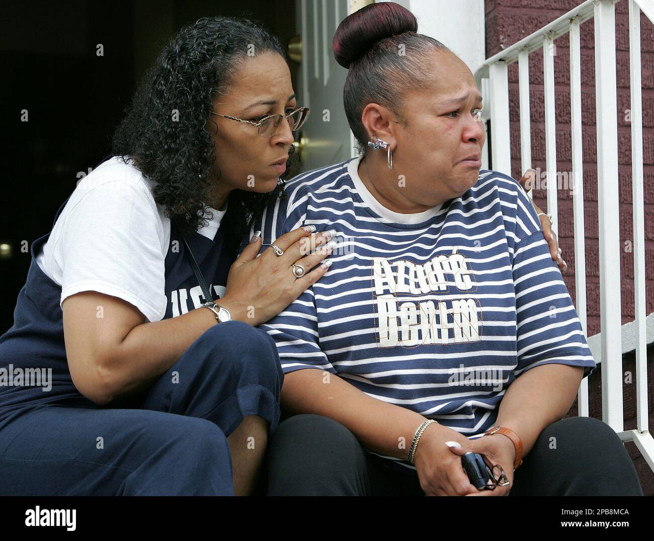 Shalga Hightower, right, is consoled by family friend Cathy Rainey ...