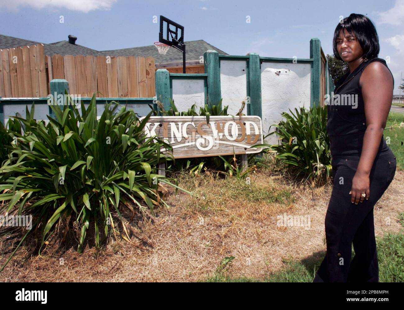Melanie Thompson poses for a photograph in front of the sign for her ...