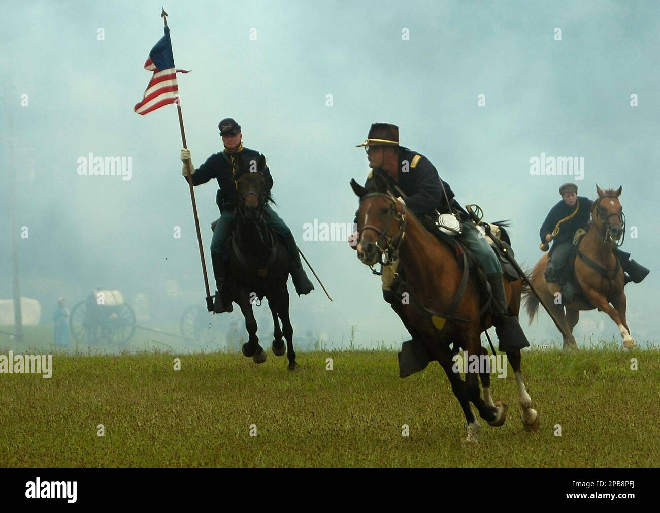Union soldiers fly the colors as they charge into battle during the ...