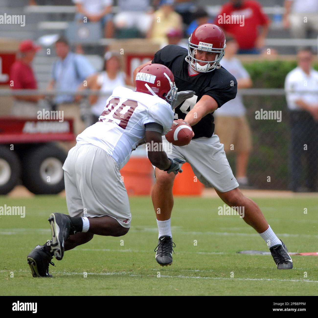 Alabama quarterback John Parker Wilson, right, hands the ball off to ...