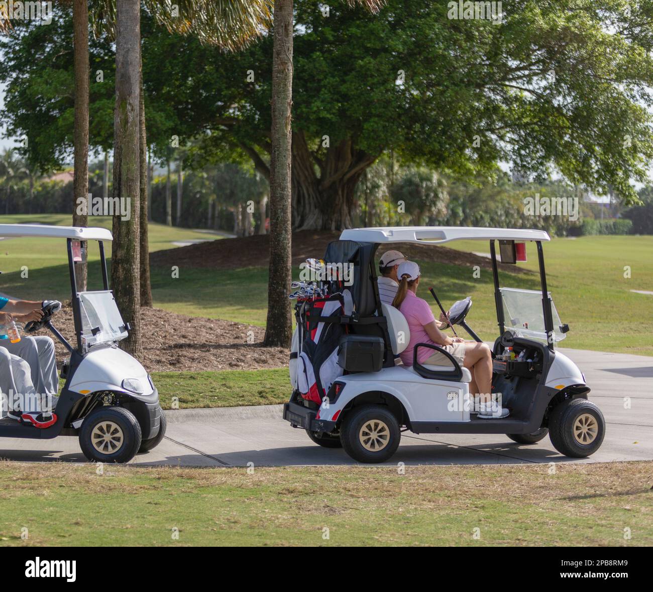Man and woman in a golf cart at Trump National Doral Golf Course, Miami ...