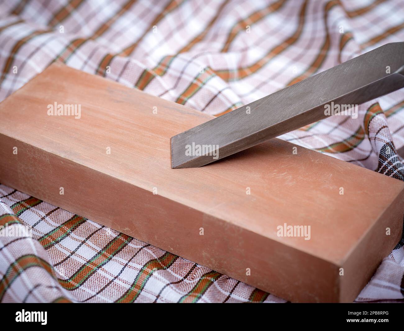 Working to get a good edge on a chisel for carving wood Stock Photo - Alamy