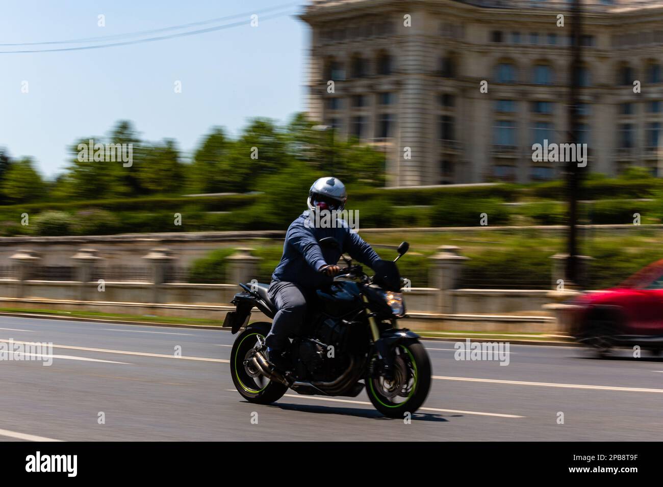 Biker on a motorcycle in traffic at rush hour in downtown area of the ...