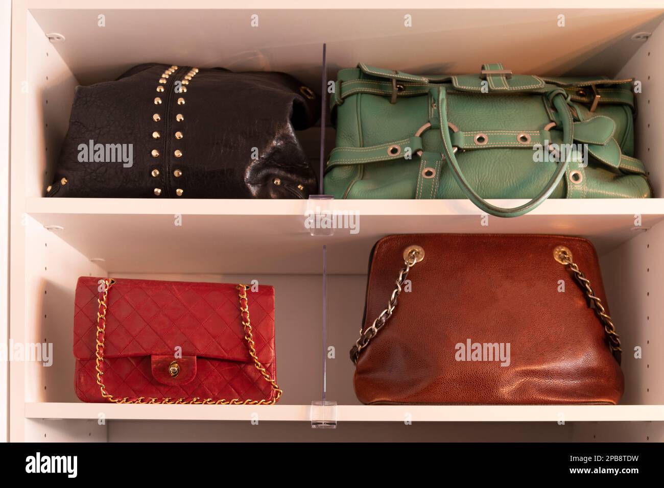 Walk-in closet with luxury bags on a shelf Stock Photo - Alamy