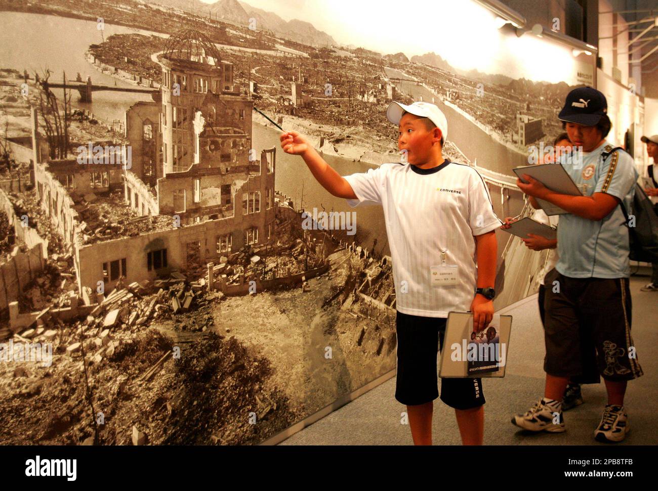 Children react to a huge photo depicting the aftermath of the Aug 6 ...