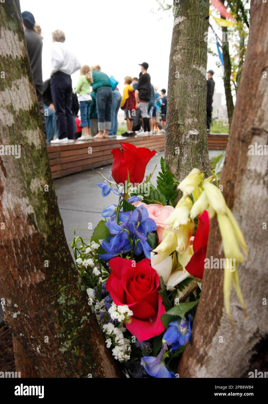 Flowers are placed in trees as a memorial to those lost in the collapse ...