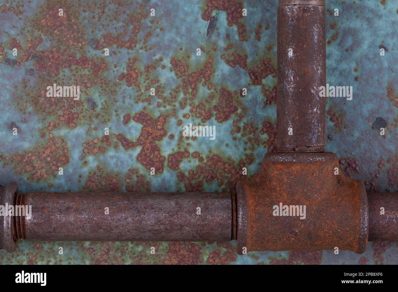 Rusty valve pipes on rusty metal wall background Stock Photo - Alamy
