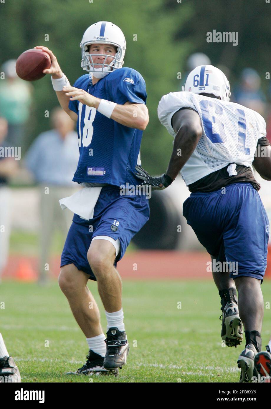 Indianapolis Colts quarterback Peyton Manning, left, is "sacked" by ...