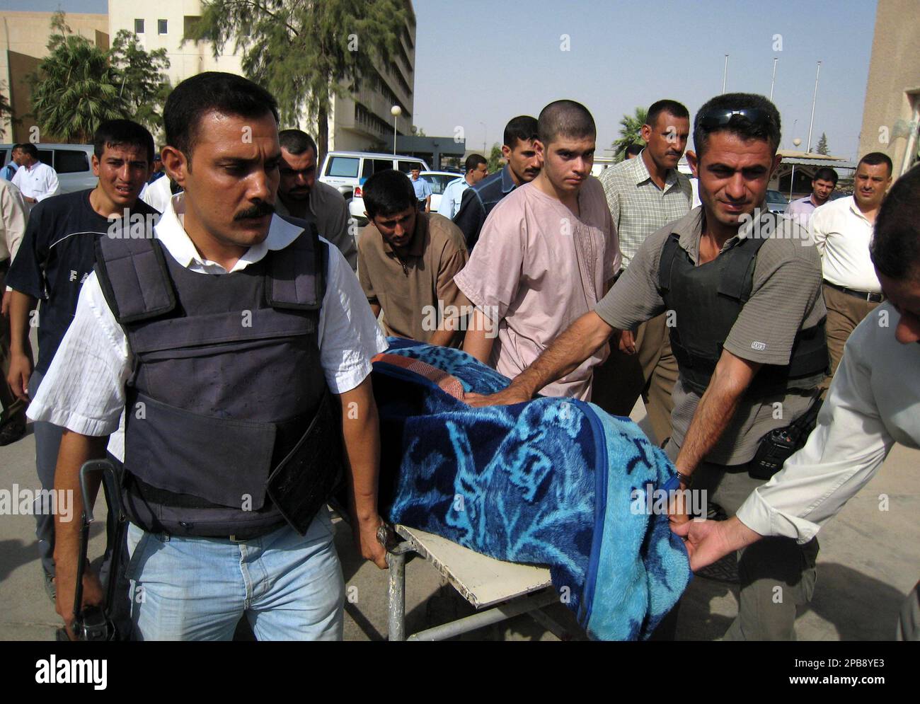 Iraqi police and relatives carry the body of Lt. Col. Ismail Salim ...