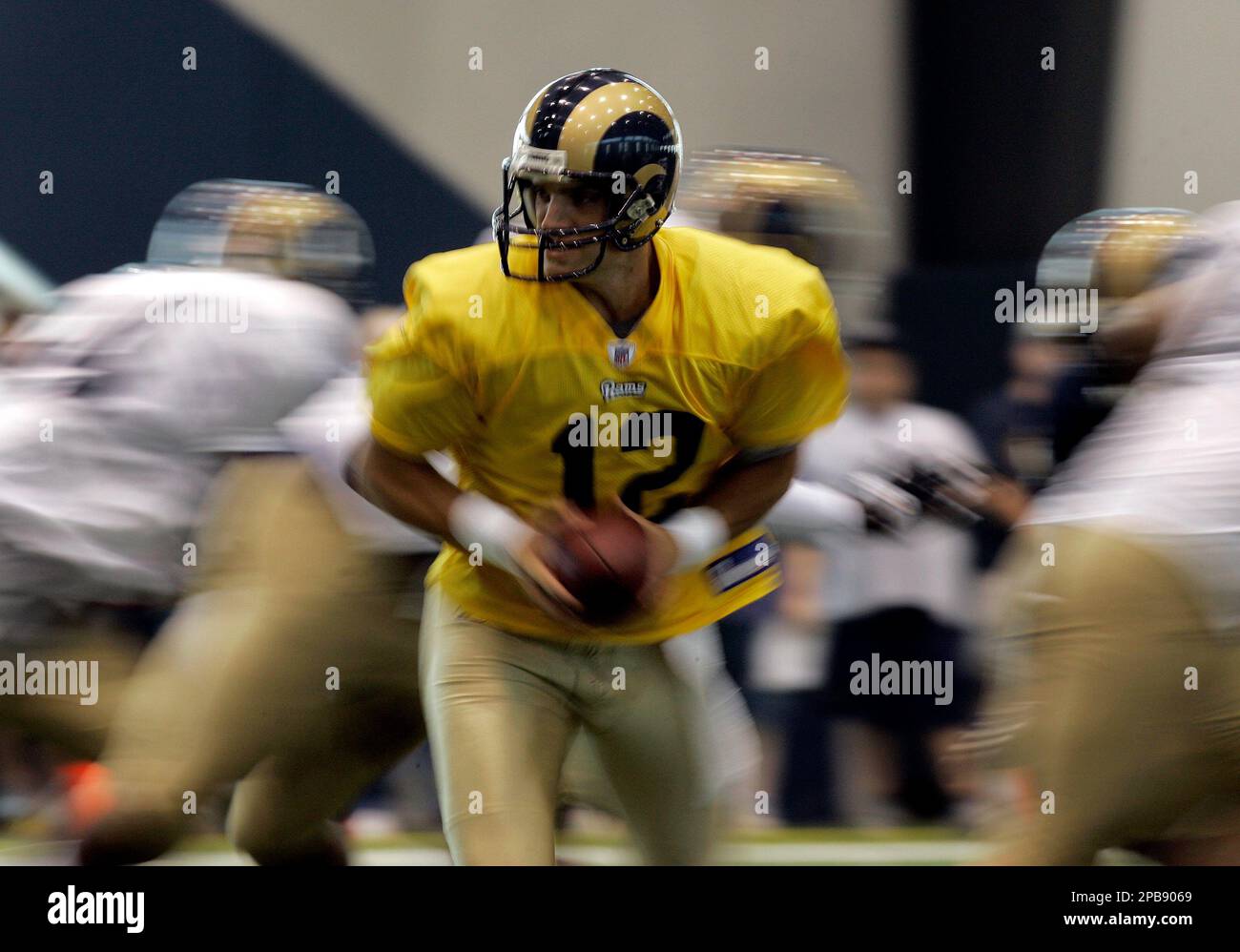 St. Louis Rams quarterback Gus Frerotte looks to hand off the ball ...