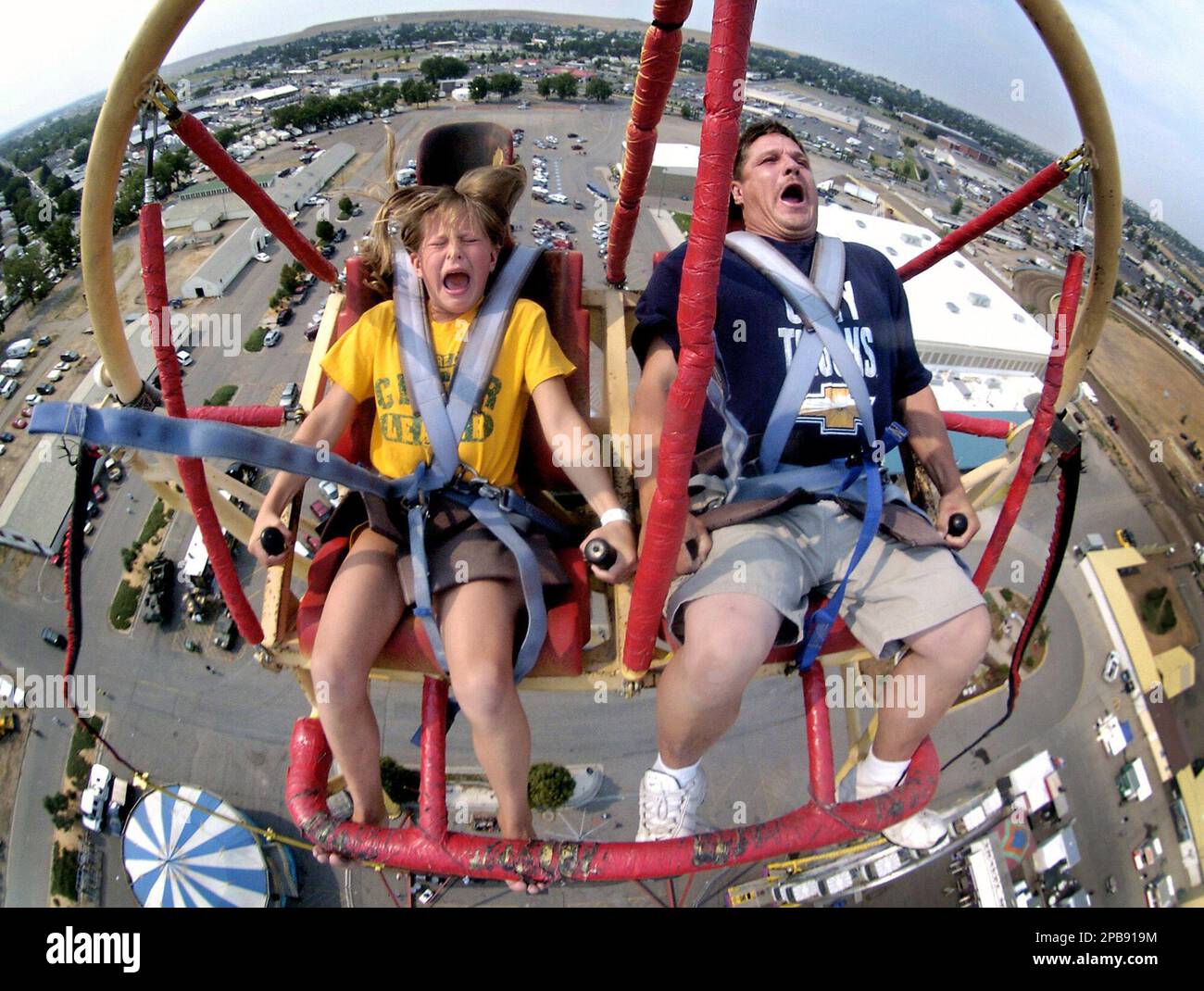 Bob Cage and his daughter Laisha, 10, reach about 180 feet in the air ...