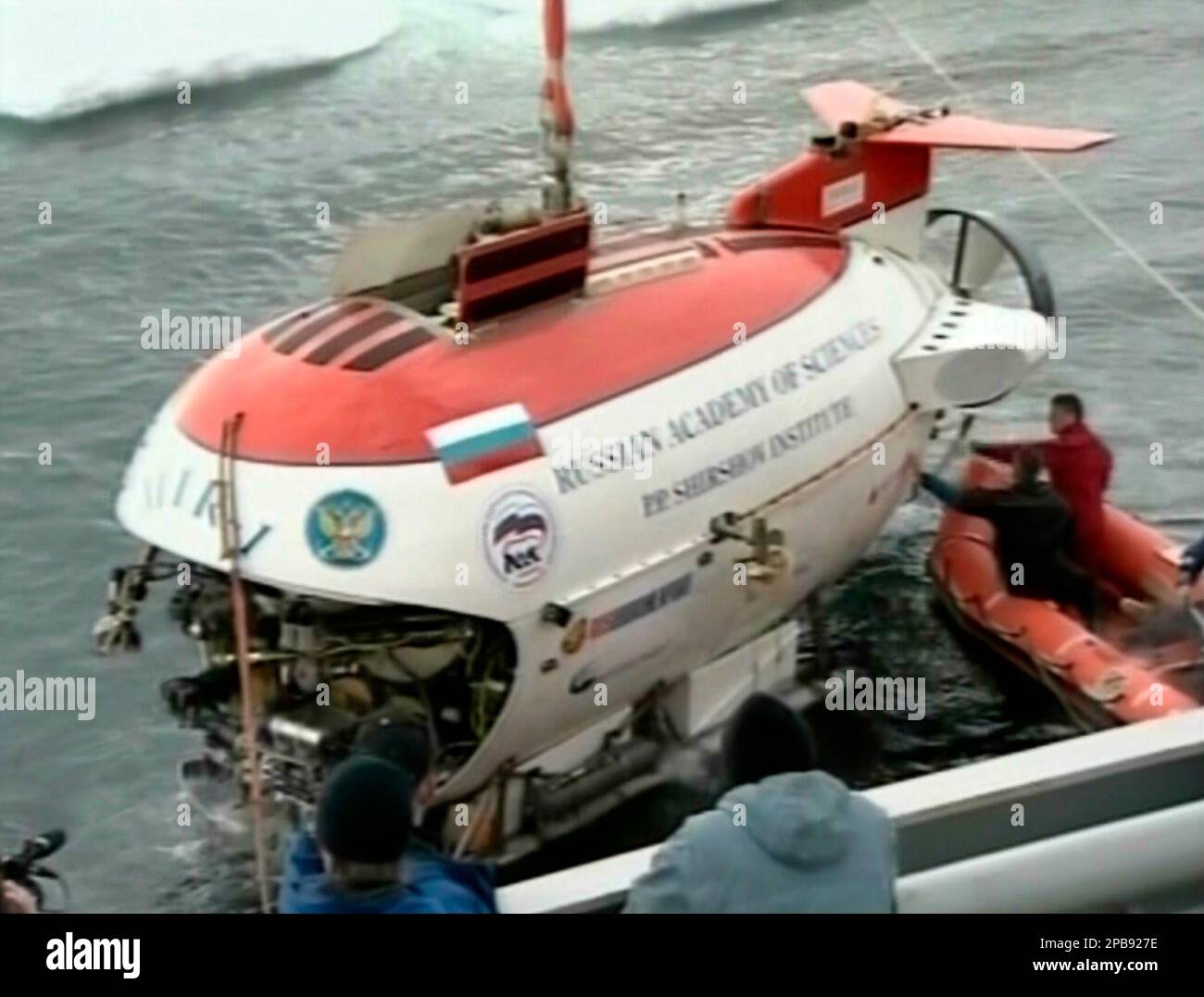 A Russian mini-submarine is uplifted out of water by the research ...