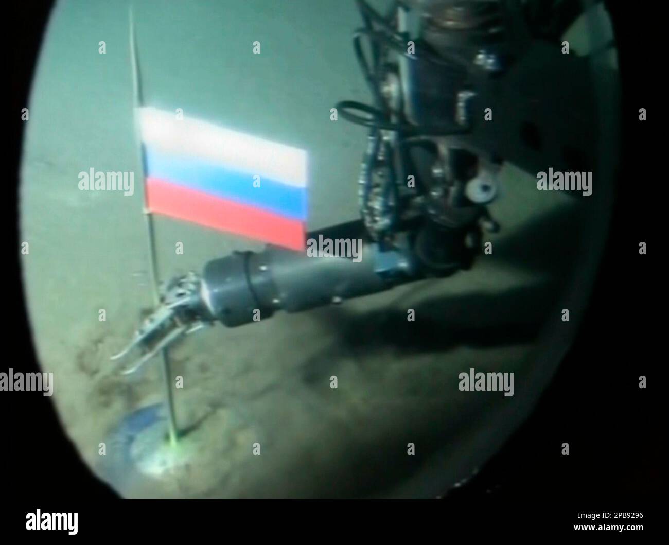 An operator of Russian mini-submarine plants a titanium capsule with ...